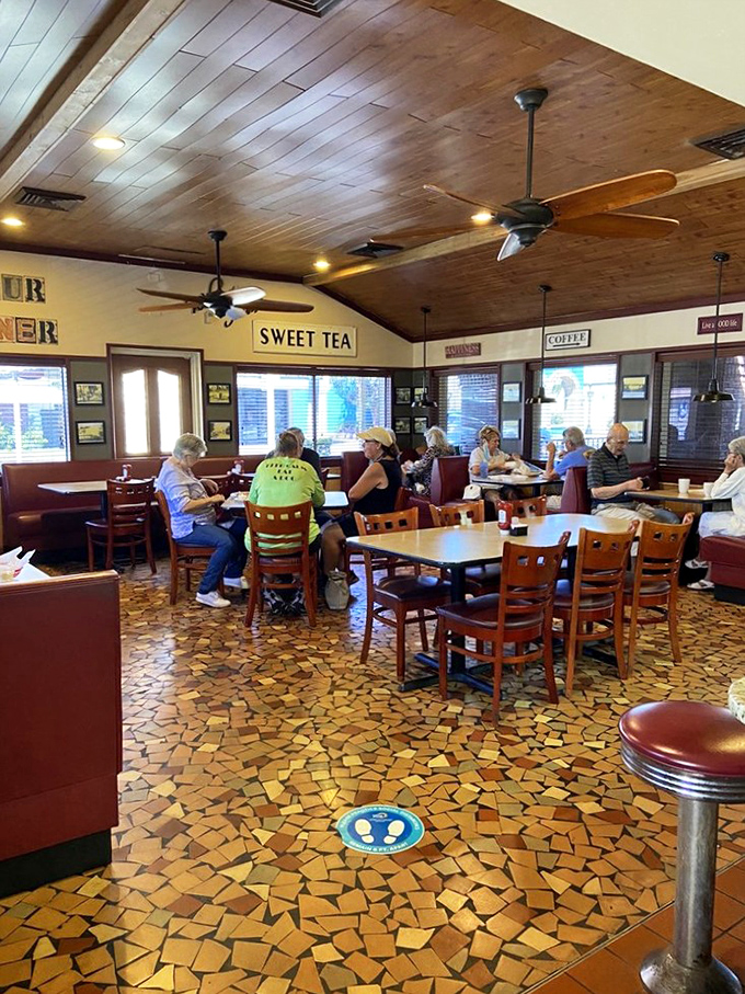 Where sweet tea flows like water and ceiling fans spin stories as old as the mosaic floor beneath your feet.