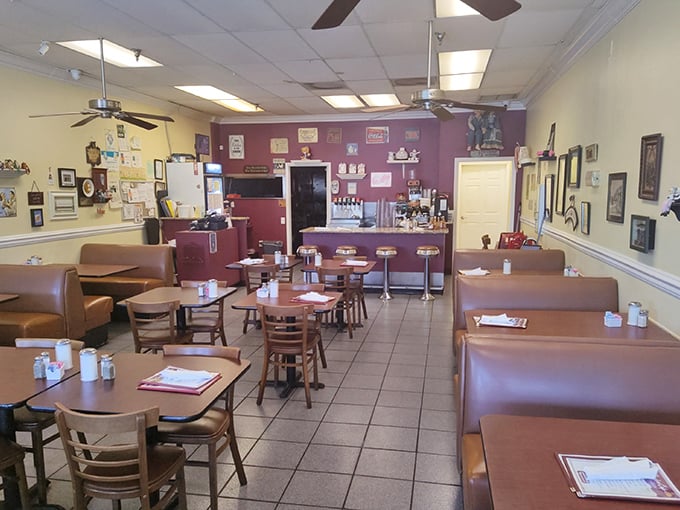 Step inside and time slows down. The burgundy accent wall, wooden tables, and ceiling fans create that "where everybody knows your name" vibe we all crave.