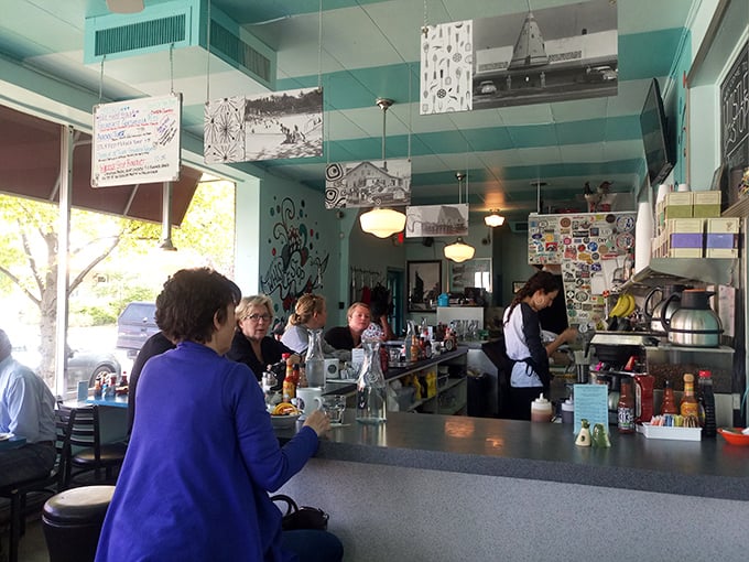 The counter seats offer front-row tickets to the breakfast ballet, where skilled cooks perform their morning choreography under turquoise ceilings.