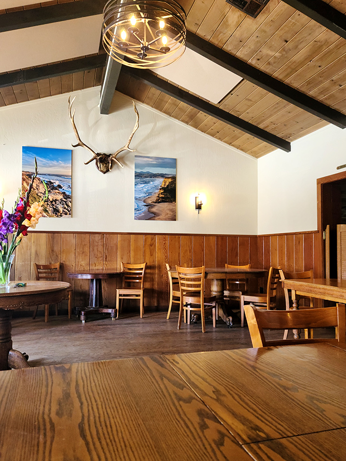 Wood-paneled walls and coastal photos create the perfect backdrop for conversations that last as long as the meal.