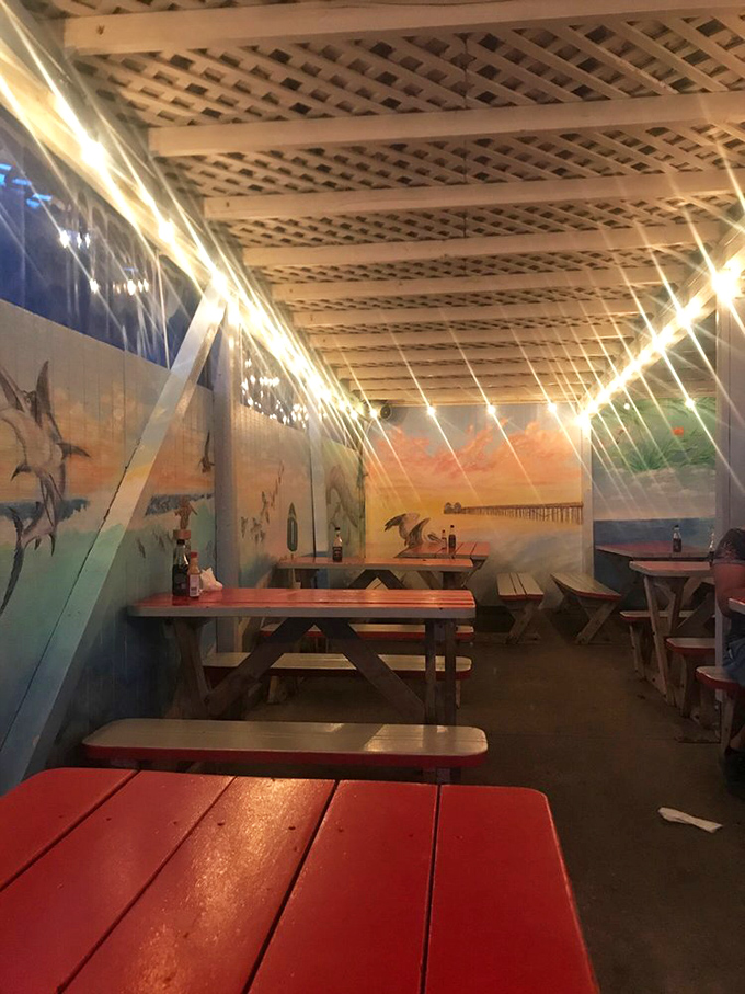 Dining under string lights with ocean-themed murals feels like a secret coastal clubhouse. The picnic tables say "casual," but the experience is anything but ordinary.