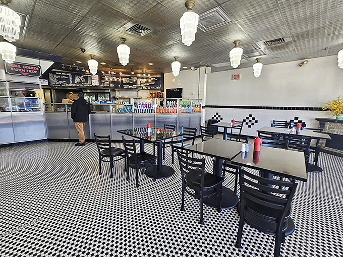 The interior's black and white checkered floor and vintage pendant lights create that perfect nostalgic diner atmosphere where cheesesteak dreams come true.