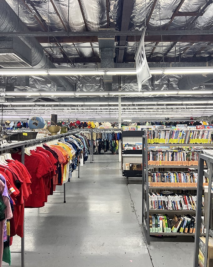 Industrial ceilings and color-coded racks create a surprisingly organized chaos&mdash;like a library where fashion history is catalogued by hue instead of Dewey Decimal.