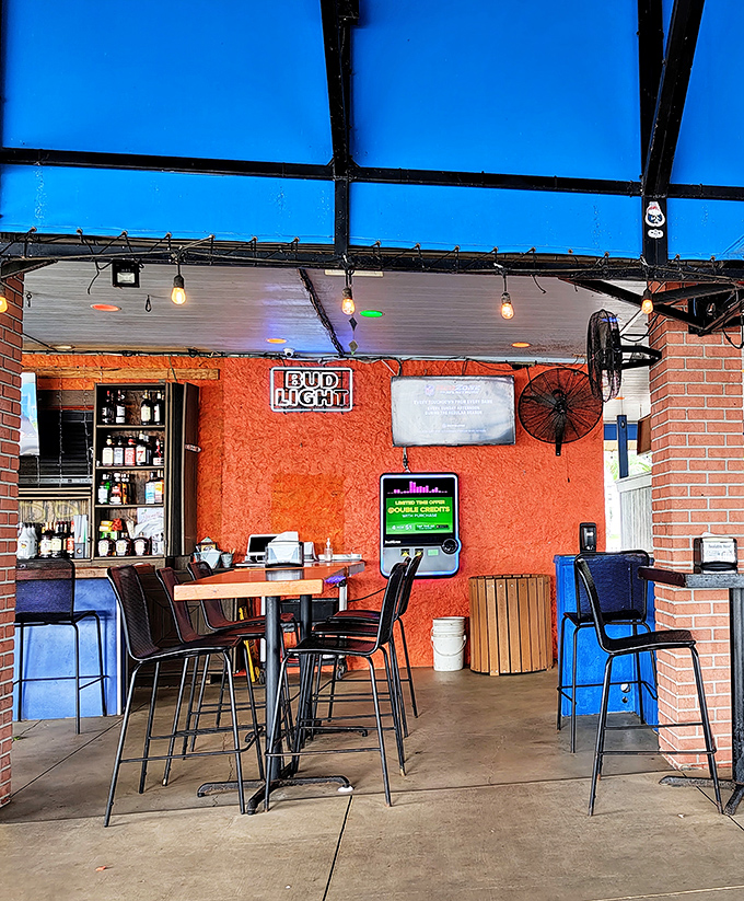 Inside, vibrant orange walls and string lights create that perfect "I'm on vacation even though I live here" ambiance.