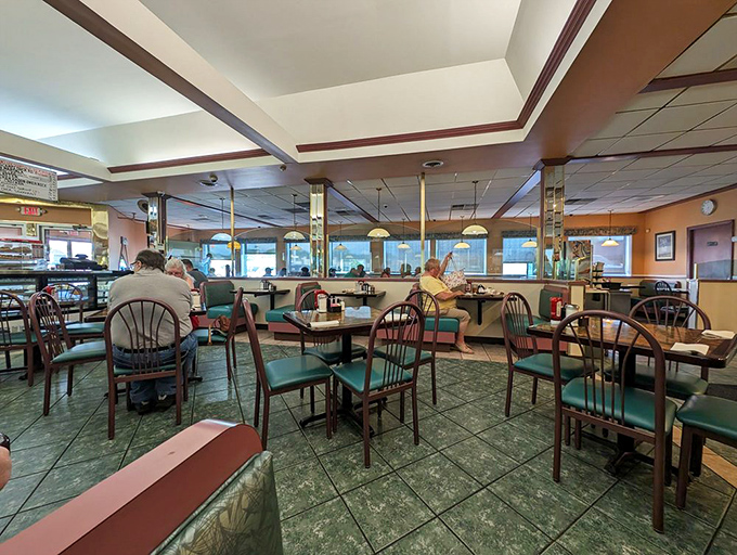 Inside, teal chairs and mirrored columns create that perfect diner atmosphere&mdash;where conversations flow as freely as the coffee refills.