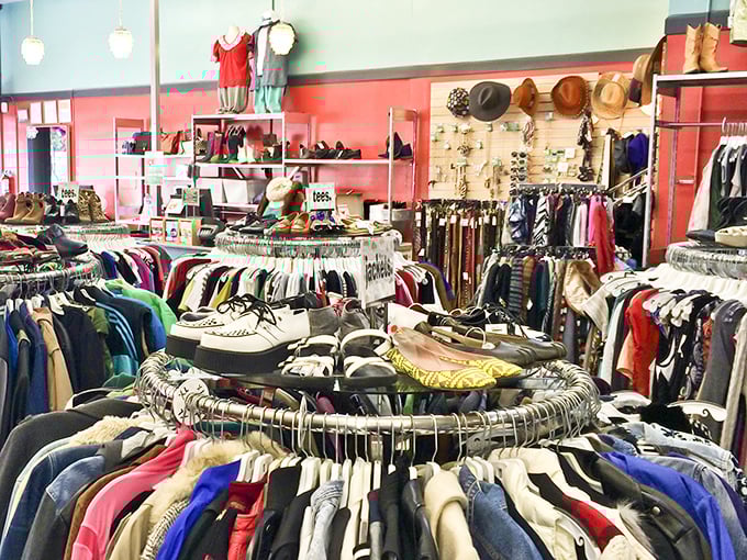 Circular racks create a treasure map of possibilities, where vintage gems and contemporary finds coexist in colorful harmony.