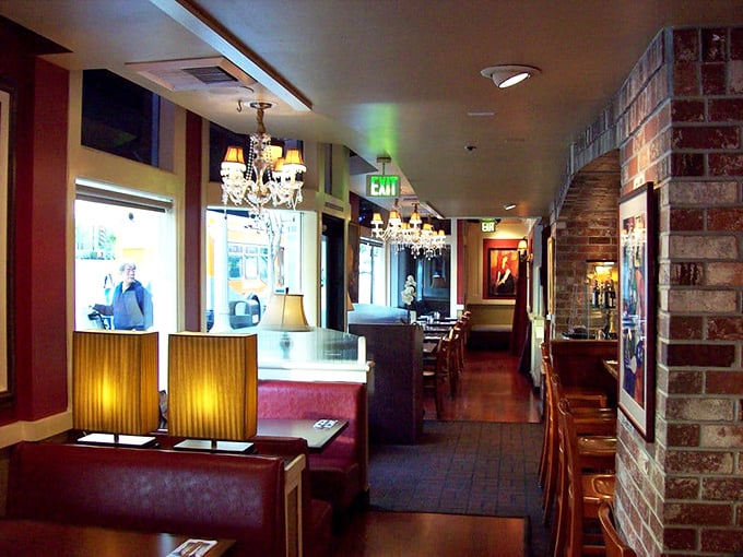 Elegant chandeliers hang above cozy brick walls and warm wood tones. This isn't just a restaurant&mdash;it's Pasadena's living room where breakfast dreams come true.