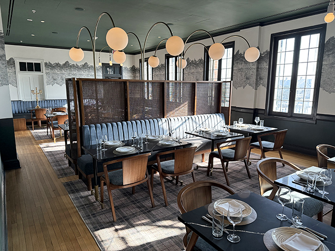 Elegant globe lighting and blue banquettes create an atmosphere that's both sophisticated and welcoming&mdash;like your stylish friend who never makes you feel underdressed.