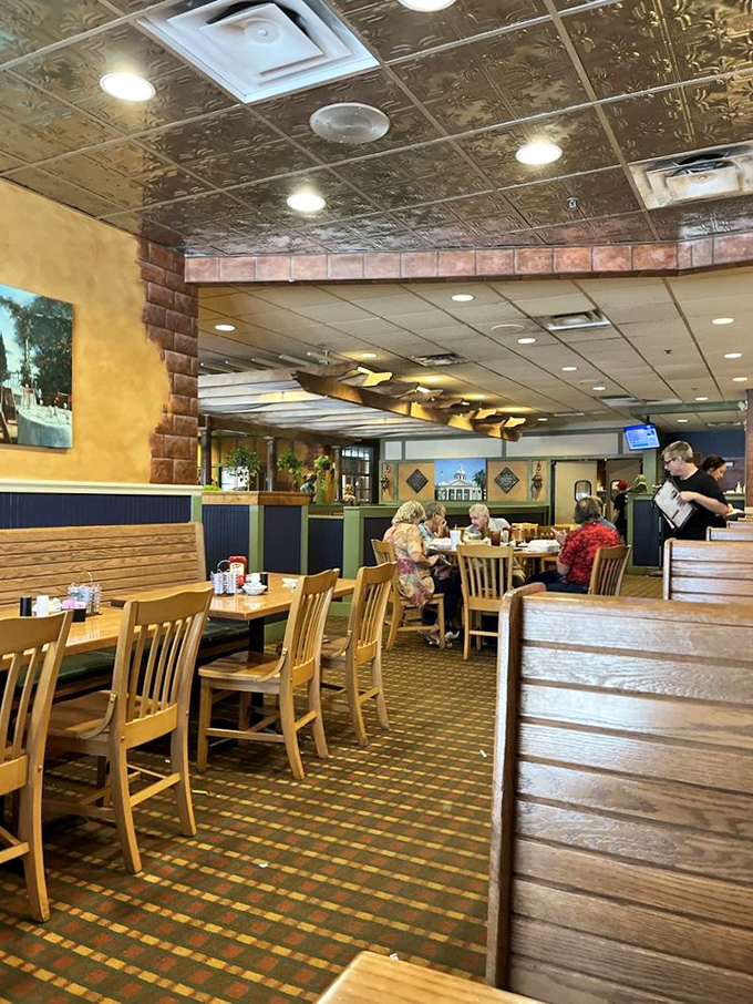 Warm wood paneling and vintage stained-glass pendant lights create the kind of cozy atmosphere that makes you want to loosen your belt before you even order.