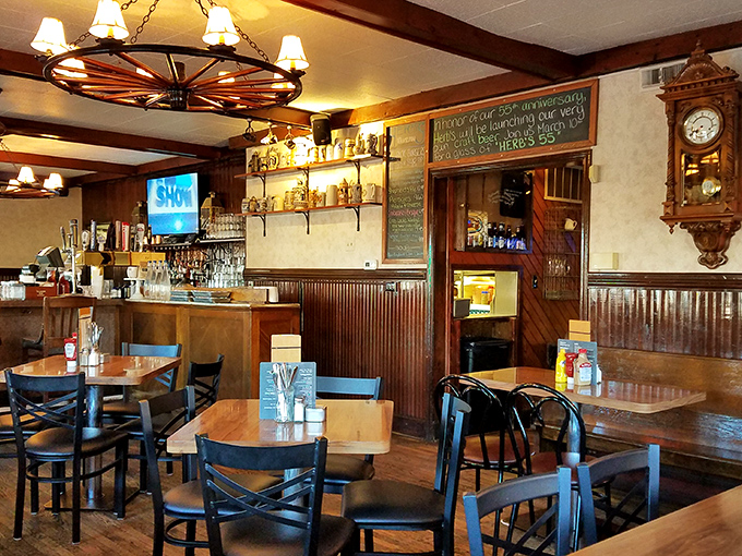 Inside, the wagon wheel chandelier and wood paneling create that amber-hued glow where memories are made and burgers achieve greatness.