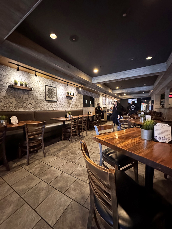 Modern rustic meets casual elegance inside. The warm wood tables and stylish wallpaper create an atmosphere where both first dates and regular Friday gatherings feel equally at home.