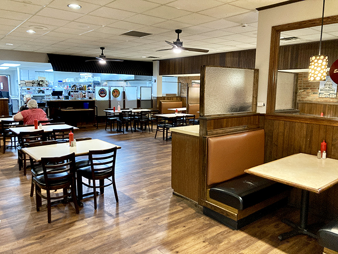 Inside, wood-paneled walls and comfortable booths create that perfect small-town restaurant atmosphere where conversations flow as easily as the coffee.