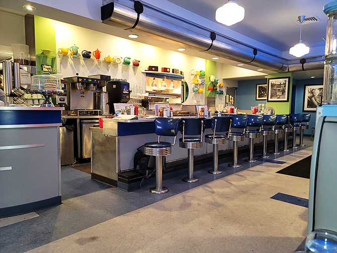 Classic diner counter magic where strangers become friends. Those blue vinyl stools have witnessed countless first dates, business deals, and "I-can't-believe-I-ate-the-whole-thing" moments.