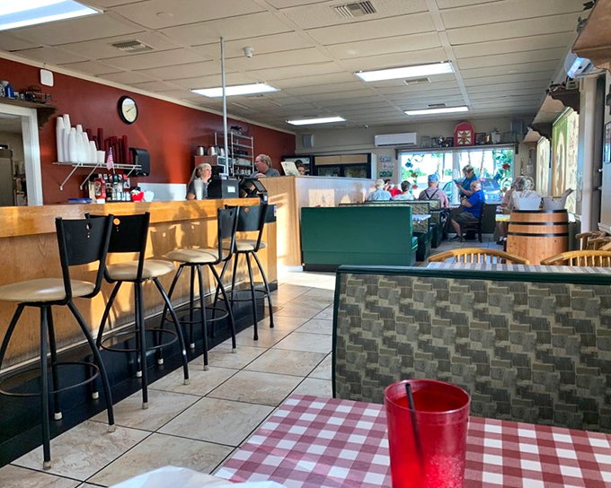 Red walls and checkered tablecloths create the perfect backdrop for serious breakfast business. This is where morning magic happens, no reservations required.