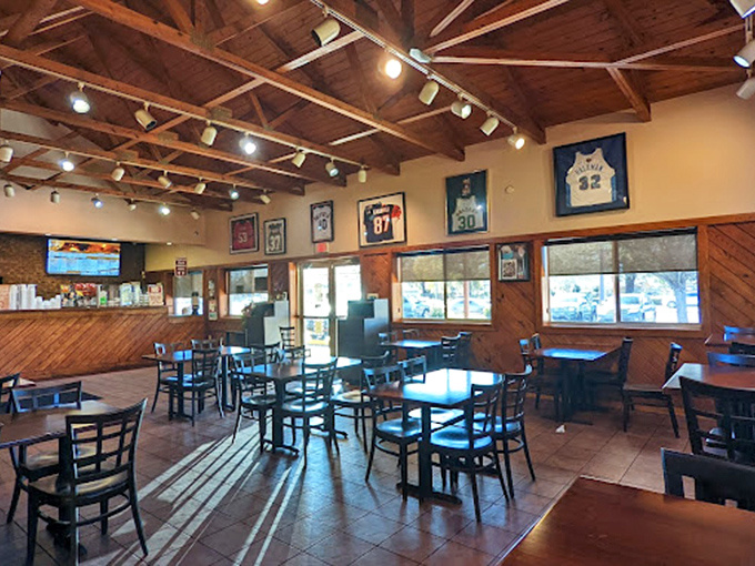 Sports jerseys watch over diners like guardian angels of flavor in a dining room where conversations flow as freely as the sweet tea.