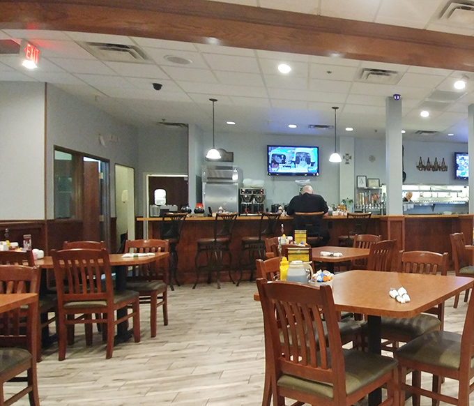 The warm wooden interior invites you to settle in at tables that have likely witnessed countless coffee refills and hearty conversations.