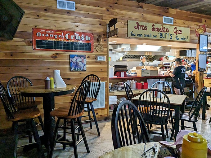 Wooden walls tell stories while that cheeky sign promises what your nose already knows. The open kitchen layout means transparency isn't just a buzzword&mdash;it's dinner and a show.