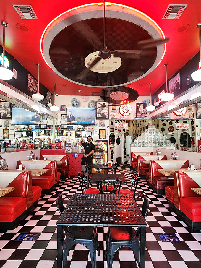 Step inside and the 1950s embrace you completely. Vinyl records suspended from a cherry-red ceiling watch over checkerboard floors and fire-engine booths.