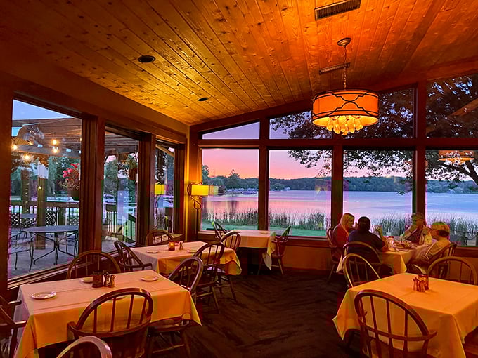 Sunset transforms the dining room into a magical experience, where pine ceilings and panoramic lake views compete with what's on your plate.