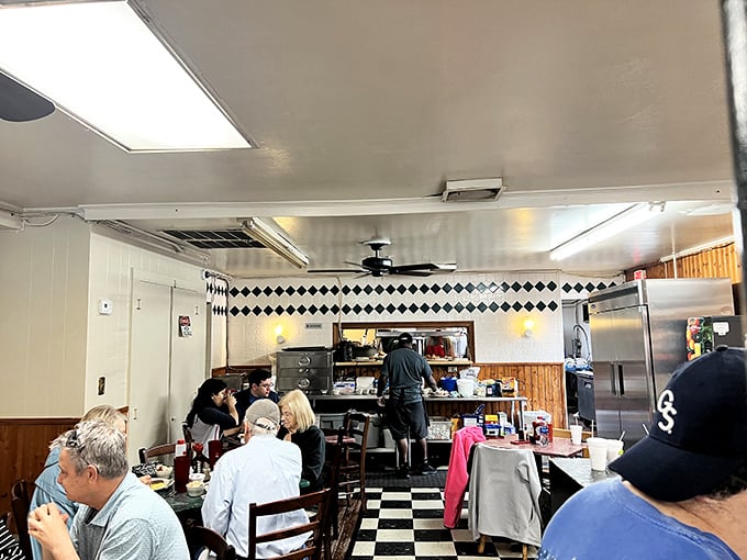 Inside, the classic black and white checkered floor sets the stage for breakfast theater, where Southern hospitality is always the star of the show.
