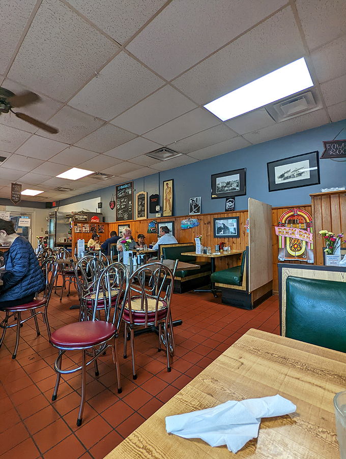 Classic diner ambiance with wood paneling, blue walls adorned with local photographs, and those unmistakable red tile floors—comfort before you even taste the food.
