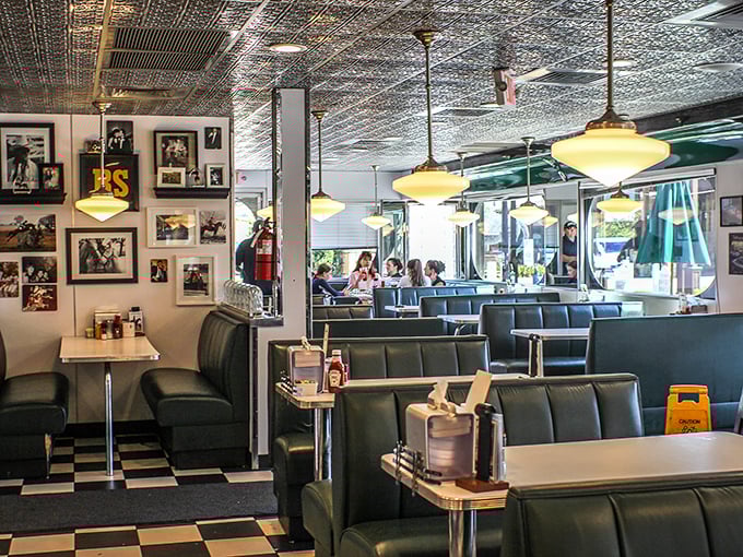 Classic Americana lives in every corner, from the pristine tin ceiling to those blue vinyl booths that have cradled countless happy diners through breakfast bliss.