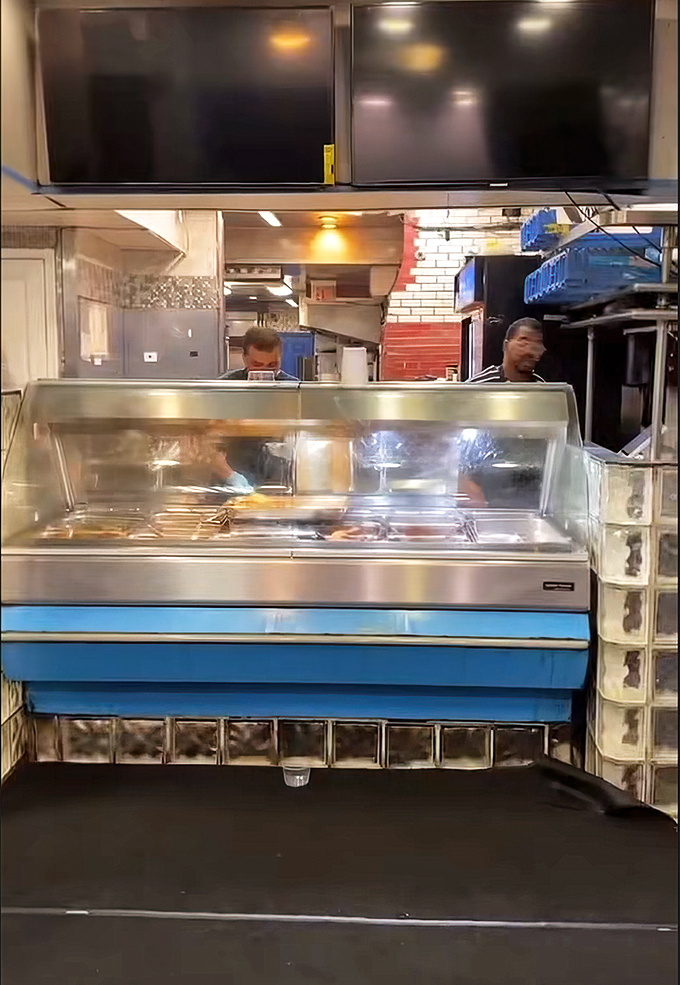 Behind the counter, culinary magic happens. This no-frills setup focuses on what matters most &ndash; getting exceptional food from their hands to yours.