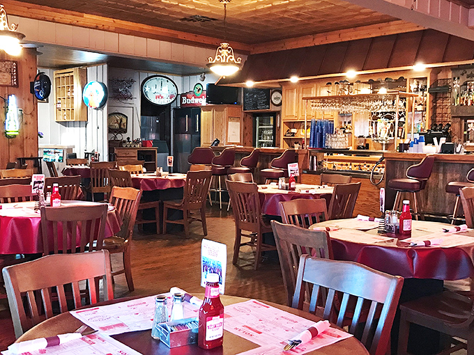 Wooden paneling, red tablecloths, and vintage clocks create that perfect "time stands still" atmosphere where the only urgency is deciding what to order first.