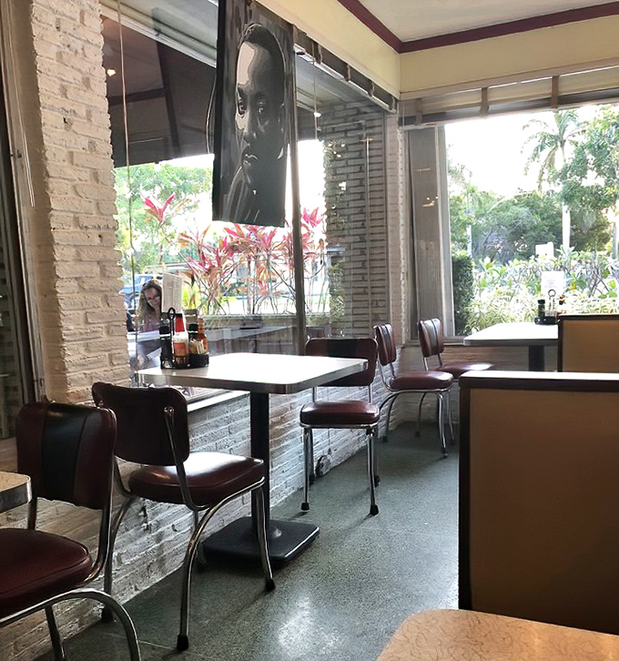 Classic red vinyl chairs against white brick walls create that perfect retro vibe&mdash;like sitting in a living postcard from 1950s Florida that somehow serves incredible food. 