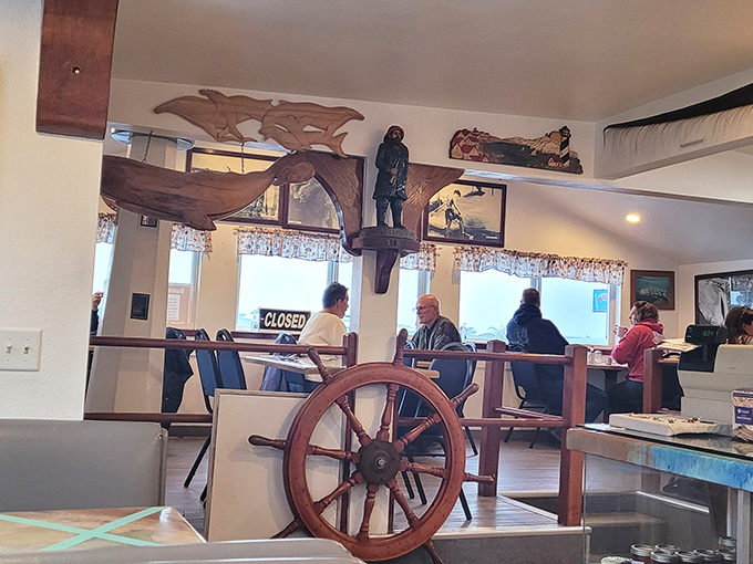 Maritime memorabilia and ship wheels create the perfect backdrop for serious seafood conversations.