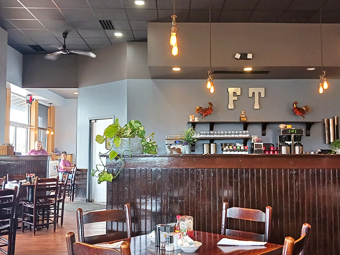 Edison bulbs cast a warm glow over wooden accents and potted plants, creating that perfect "comfortable but not trying too hard" vibe.