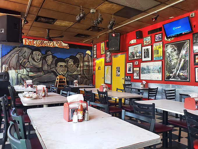 Blues legends watch over diners from vibrant murals as the red and yellow walls create the perfect backdrop for barbecue bliss.
