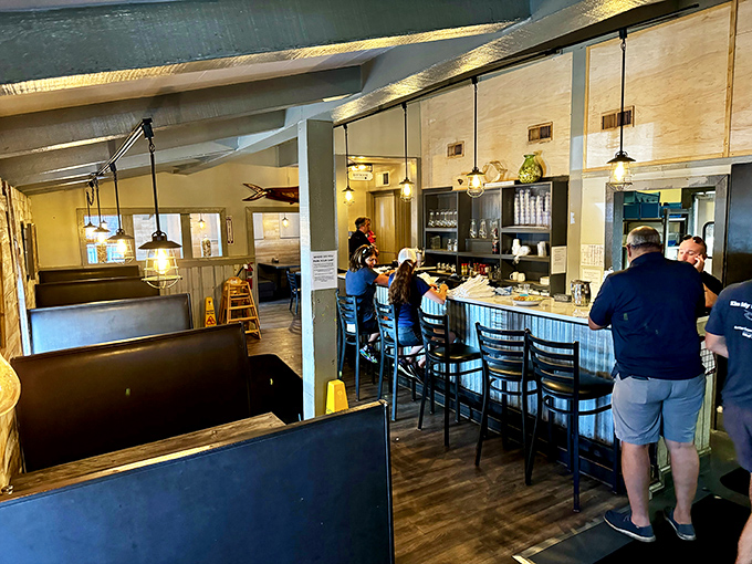 Inside, pendant lights cast a warm glow over the casual dining space where locals and visitors gather to experience seafood that speaks for itself.