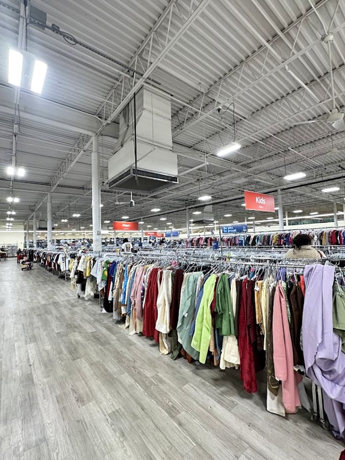 Endless racks stretch toward the horizon under industrial ceilings&mdash;this isn't shopping, it's an expedition with color-coded trail markers.