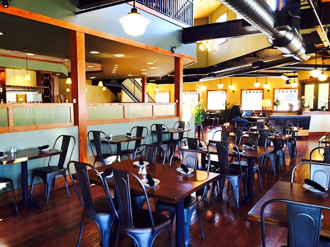 Industrial-chic meets maritime comfort inside, where wooden beams and warm yellow walls create the perfect backdrop for seafood indulgence.