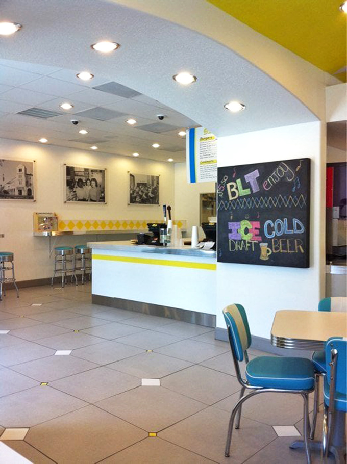 Vintage photographs and turquoise chairs blend nostalgia with modern comfort in this welcoming dining space.