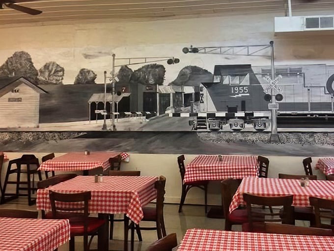 Red and white checkered tablecloths set against a historic train mural &ndash; dining here is like stepping into a Norman Rockwell painting of Southern life.
