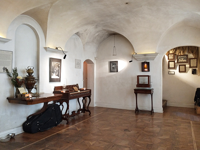 Step into the twilight zone of museums, where white arched ceilings and antique furniture create an atmosphere somewhere between Victorian parlor and dream sequence.