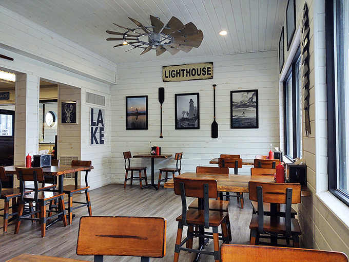 Nautical charm meets comfort in this bright, airy dining space. The "LIGHTHOUSE" sign isn't just decor—it's a beacon guiding hungry travelers to seafood nirvana.