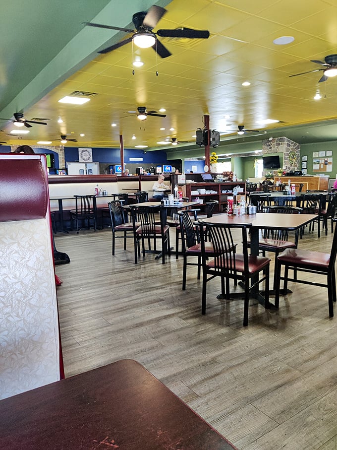 Step inside to a world where yellow ceilings and ceiling fans create that unmistakable diner atmosphere. Comfort begins before the food arrives.