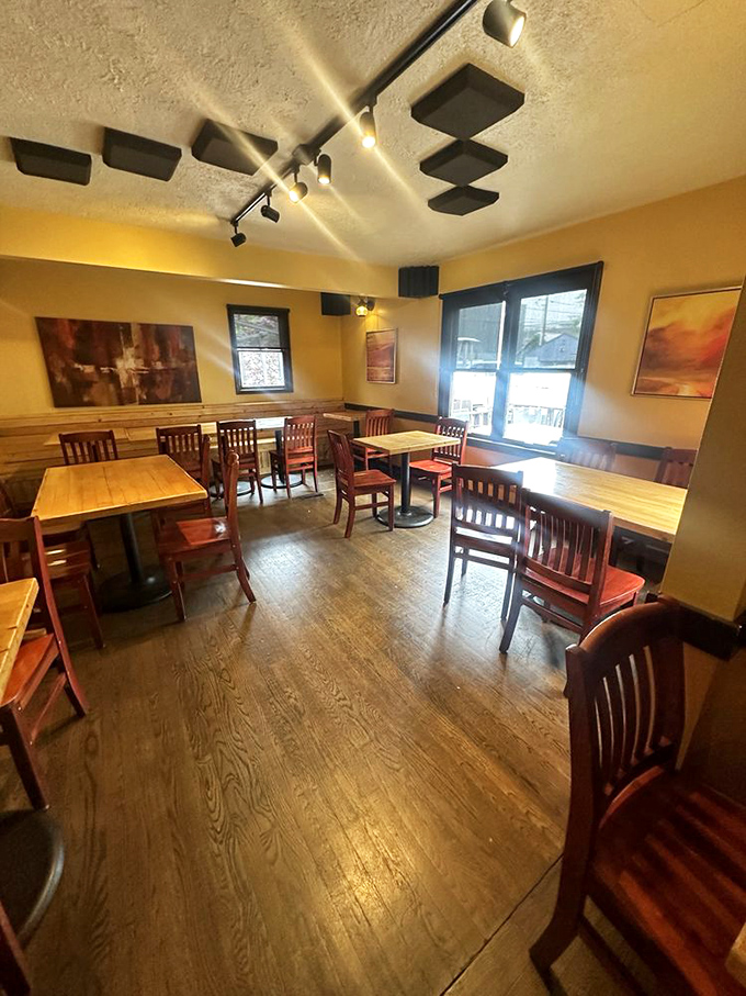 Warm wooden tables and yellow walls create a cozy sanctuary for serious eating. This isn't fancy dining—it's the comfortable living room of your food-obsessed friend.