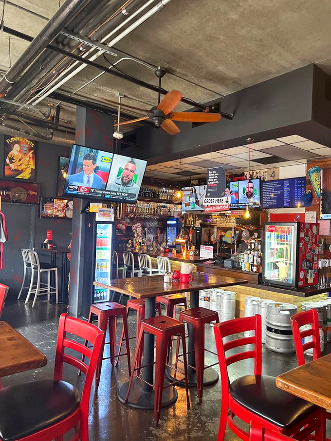 Industrial chic meets seafood sanctuary inside, where orange ceiling fans lazily spin above red chairs and cold beer awaits.