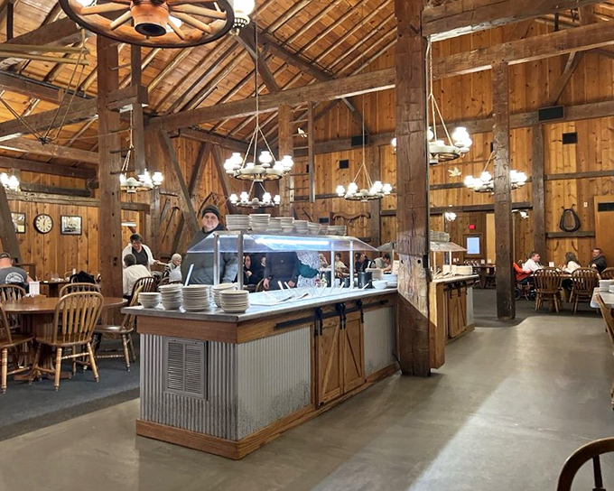 Massive wooden beams and wagon wheel chandeliers create a cathedral of comfort food. This isn't Pinterest-barn; it's the real architectural deal.