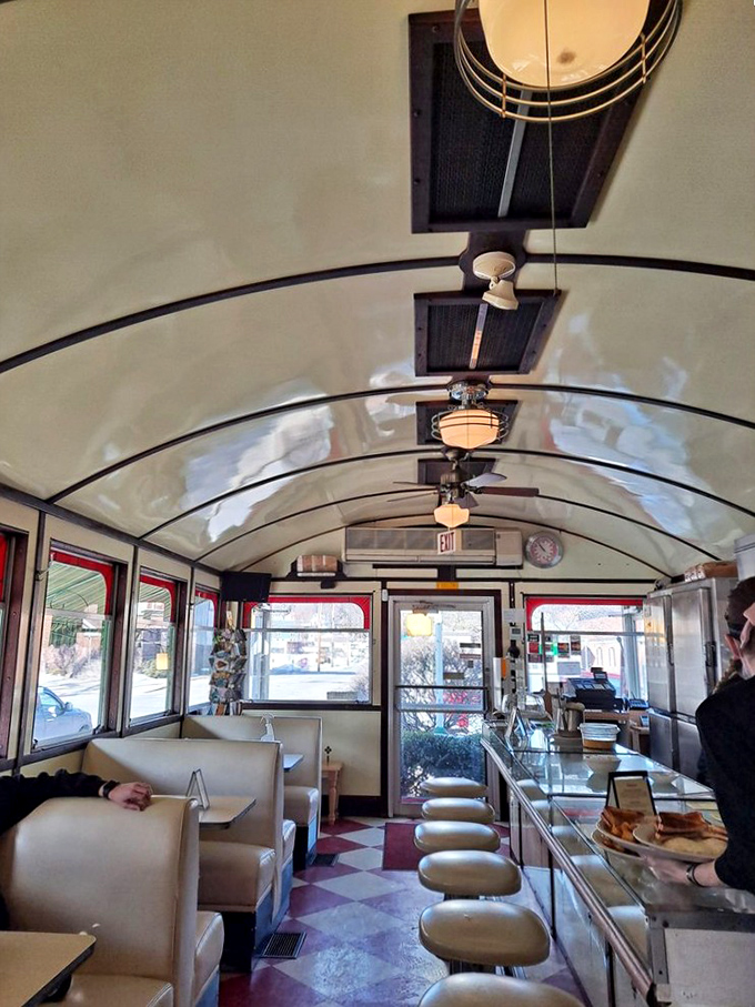 Step inside and the curved ceiling transports you to a simpler era, where counter seats await hungry travelers and vinyl booths promise comfort.