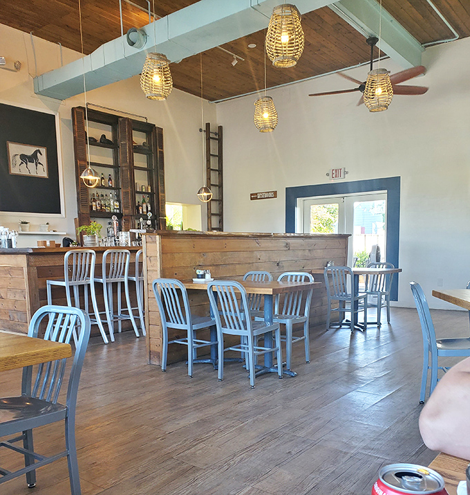 Rustic meets refined in this airy interior where wooden beams, woven pendant lights, and metal chairs create the perfect backdrop for breakfast bliss.