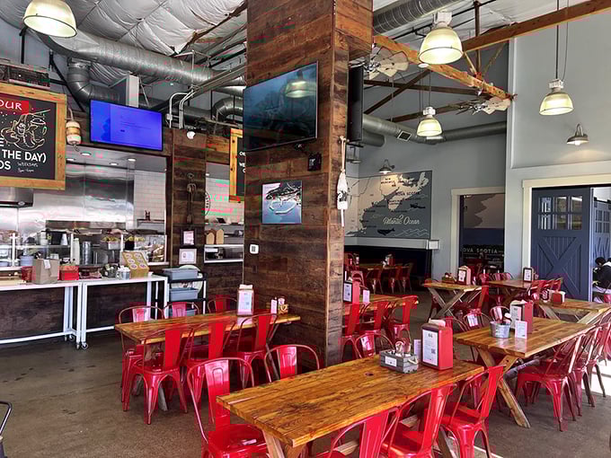 Inside, rustic wood tables meet industrial chic with those eye-catching red chairs &ndash; nautical comfort that says "stay awhile, there's lobster to devour."