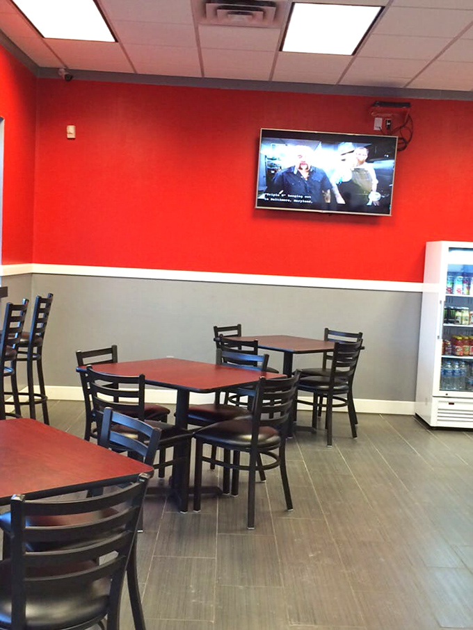 Red walls and simple furnishings create that perfect "focus-on-the-food" atmosphere. No distractions here—just you, your sandwich, and maybe whatever game is playing overhead.