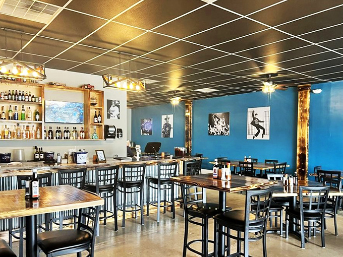 Music legends watch over diners from vibrant blue walls, creating an atmosphere that's equal parts relaxed neighborhood joint and destination dining experience.