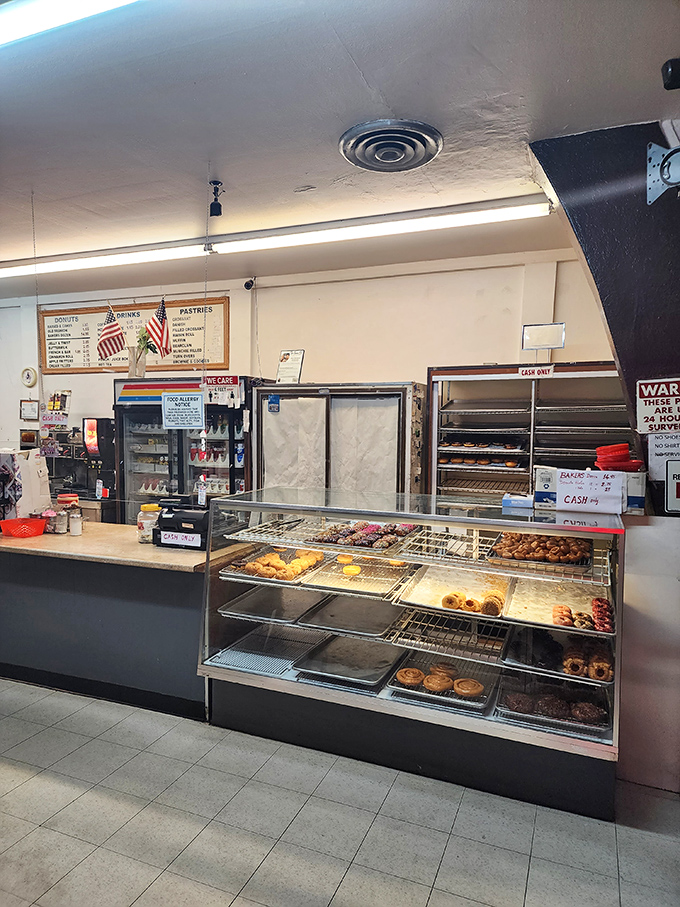 Behind the counter, trays of freshly made treasures await their destiny. This is where donut dreams become delicious reality.