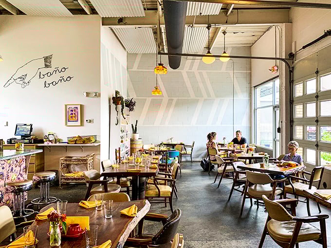 Industrial chic meets comfort at Milktooth's interior, where garage doors frame natural light and mismatched chairs invite you to settle in for something extraordinary.